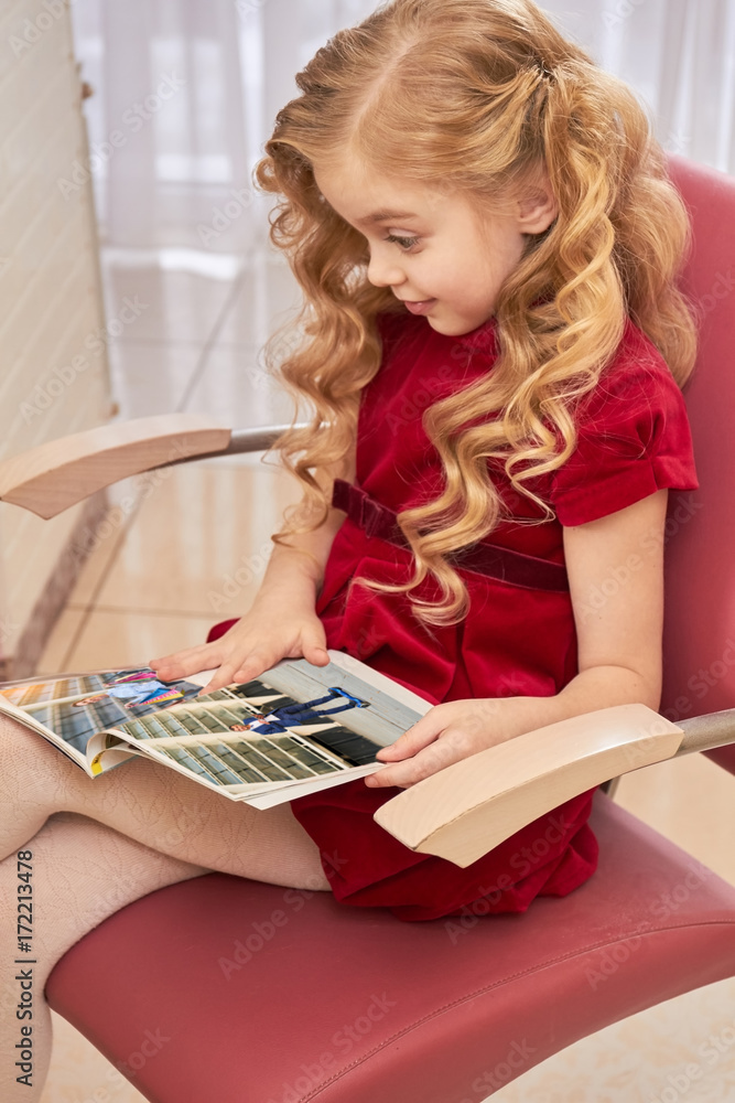 Amazed child reading fashion magazine. Surprised little girl. How media ...