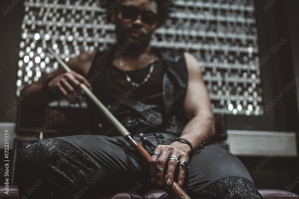 red ball, sexy Man with tattoos and jewelry with cue IN THE HANDS Stock ...