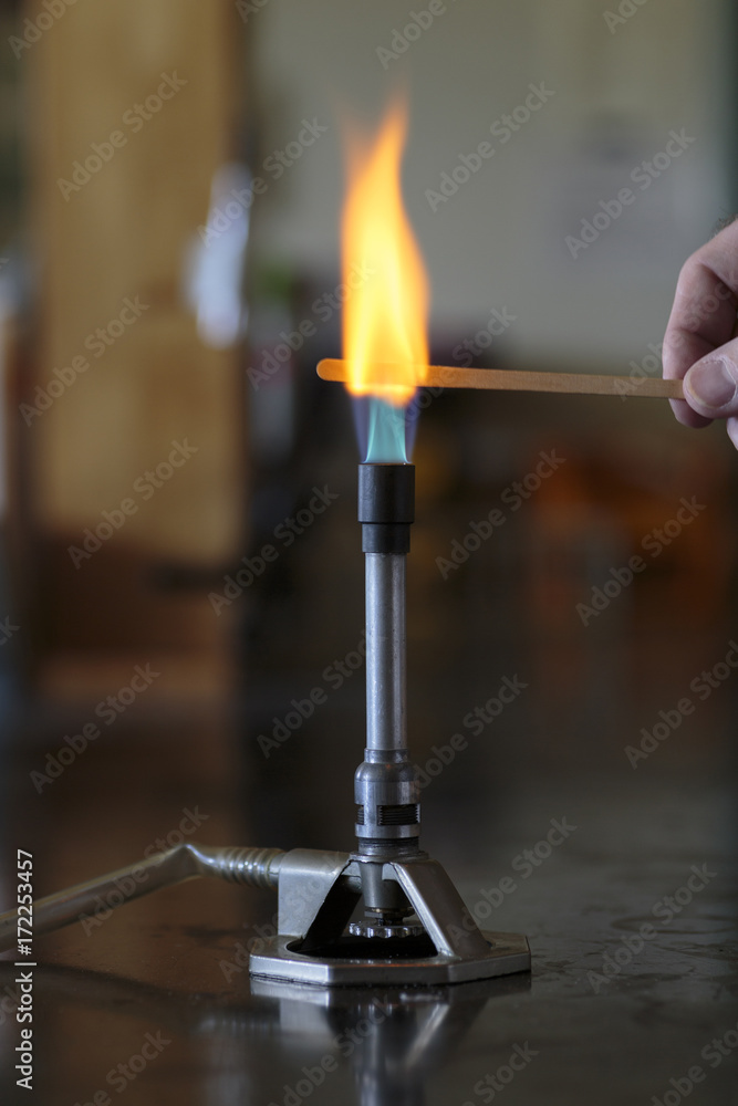 Sodium solution burning on a wooden splint in a bunsen burner flame ...