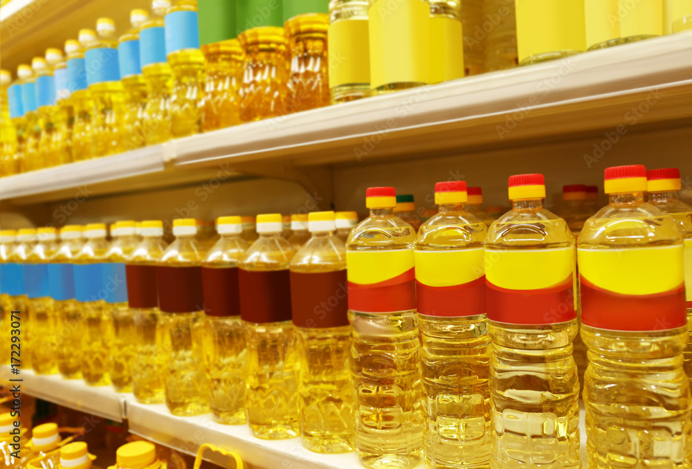 Bottles with cooking oil on shelves in supermarket Stock Photo | Adobe ...