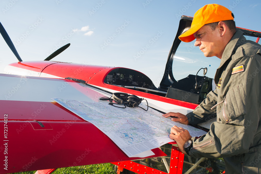 Pilot exploring map on airplane Stock Photo | Adobe Stock
