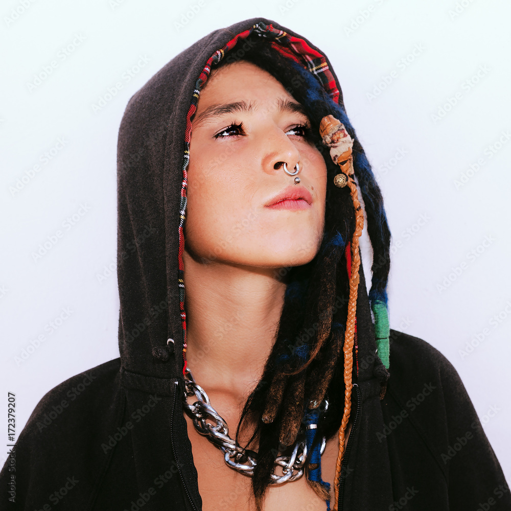 Latin girl with dreadlocks and piercings. In a black hoodie. Street ...