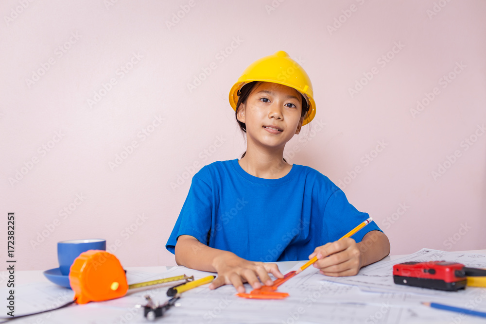 Asian girl child playing as an engineer the building layout and helmet ...