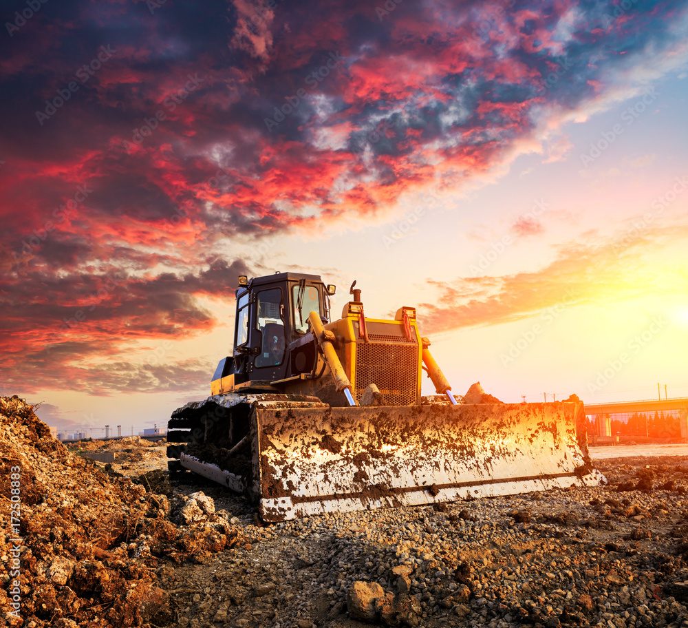 bulldozer on a building site at sunset foto de Stock | Adobe Stock