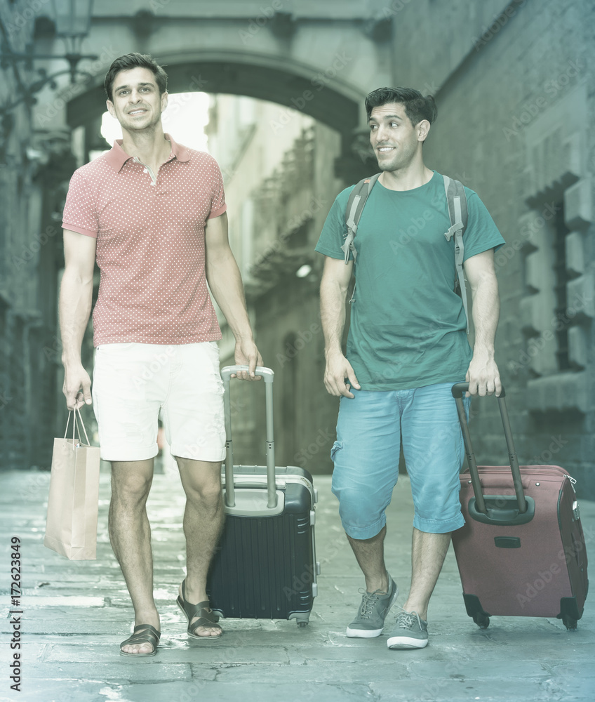 Two men friends walking together with baggage Stock Photo | Adobe Stock