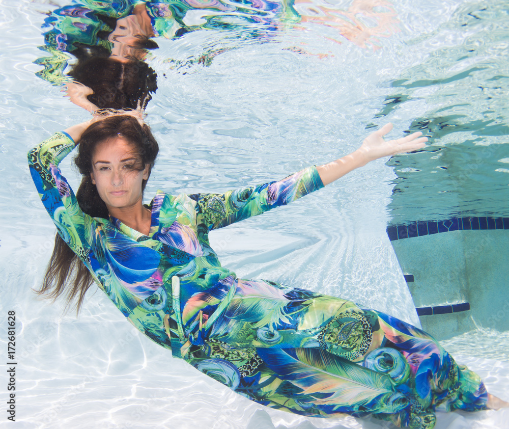 Beautiful young women in a swimsuit, or mermaids tail above and below ...