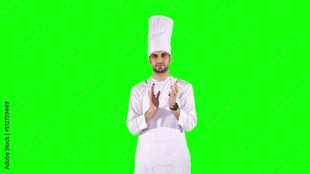 Male Caucasian chef clapping in the studio while wearing uniform and ...