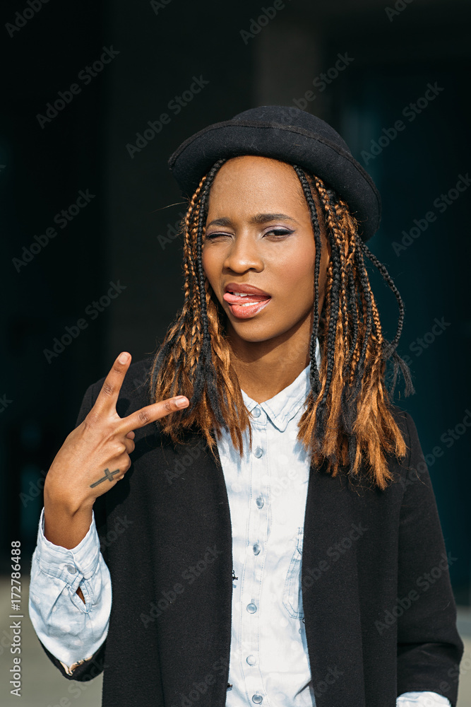 Victory gesture. Seductive young black lady. African American woman in ...