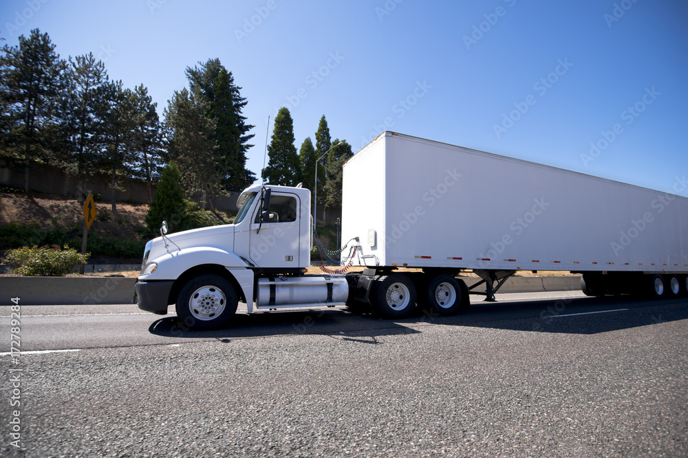 White big rig day cab semi truck and dry van trailer for local delivery ...