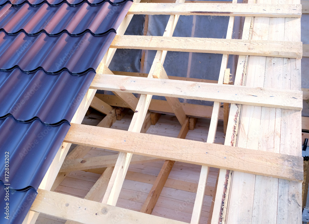 Process of metal roof mounting outside house. Wooden house country ...