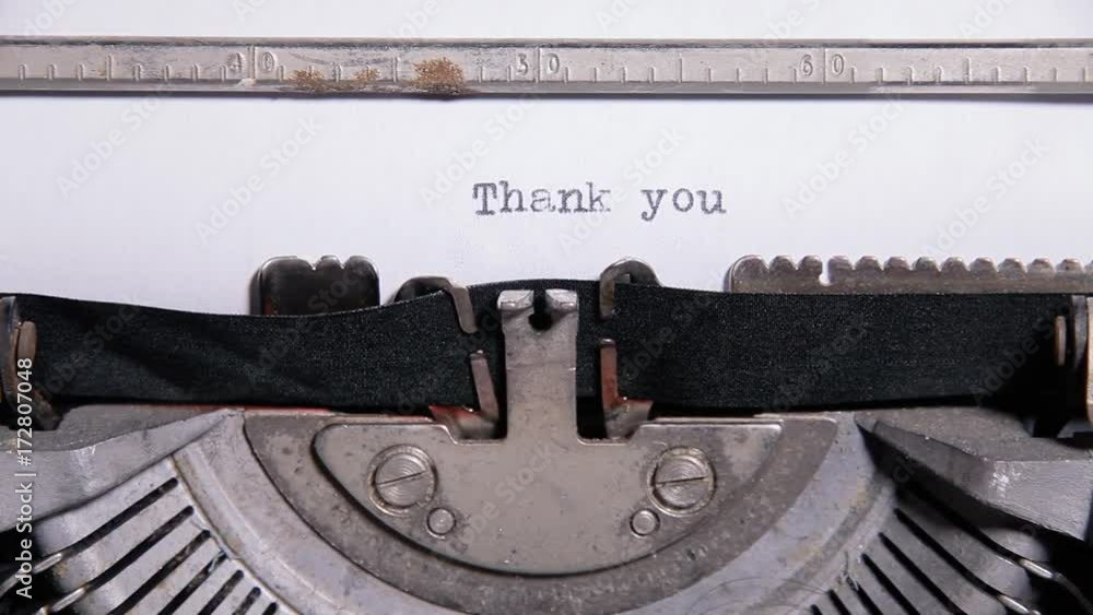 Typing the words - Thank you - on a sheet of paper with an old vintage ...