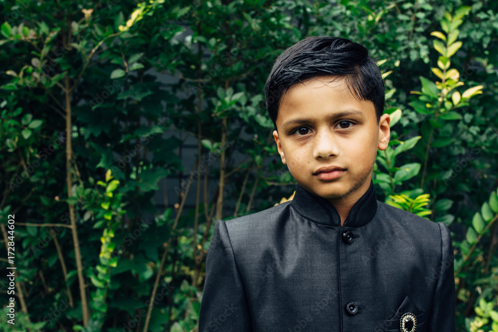 Smiling Indian boy wearing a traditional outfit Stock Photo | Adobe Stock