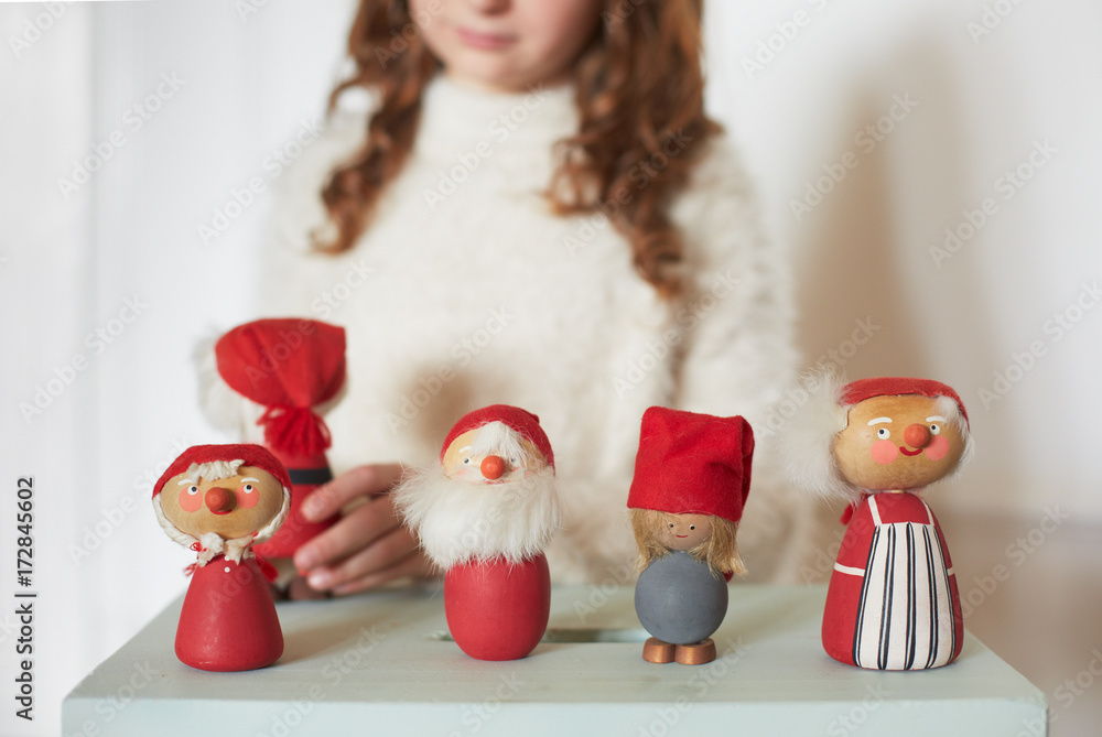 Little girl playing with figures of christmas dwarfs Stock Photo ...