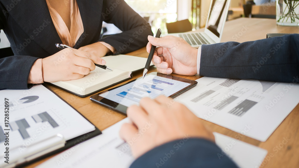 valuation business. Two young executives partner discussing with macro ...