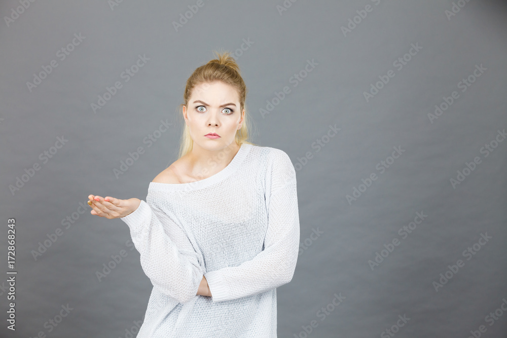 Confused young blonde woman looking suspicious Stock Photo | Adobe Stock