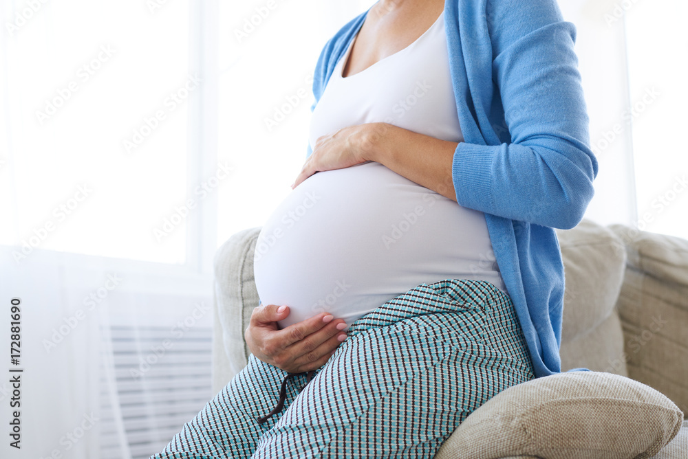 Hands fugging pregnant belly Stock Photo | Adobe Stock