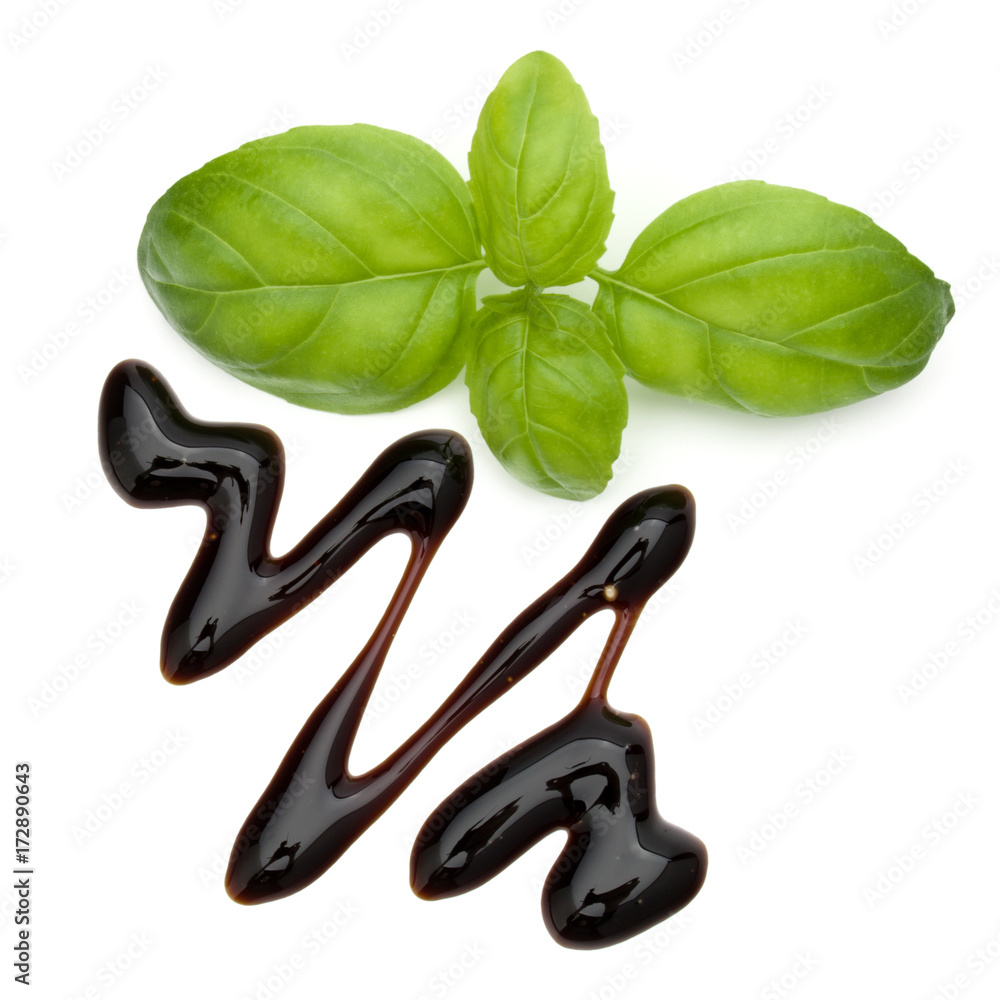 Balsamic vinegar cream and basil leaves isolated on white background ...