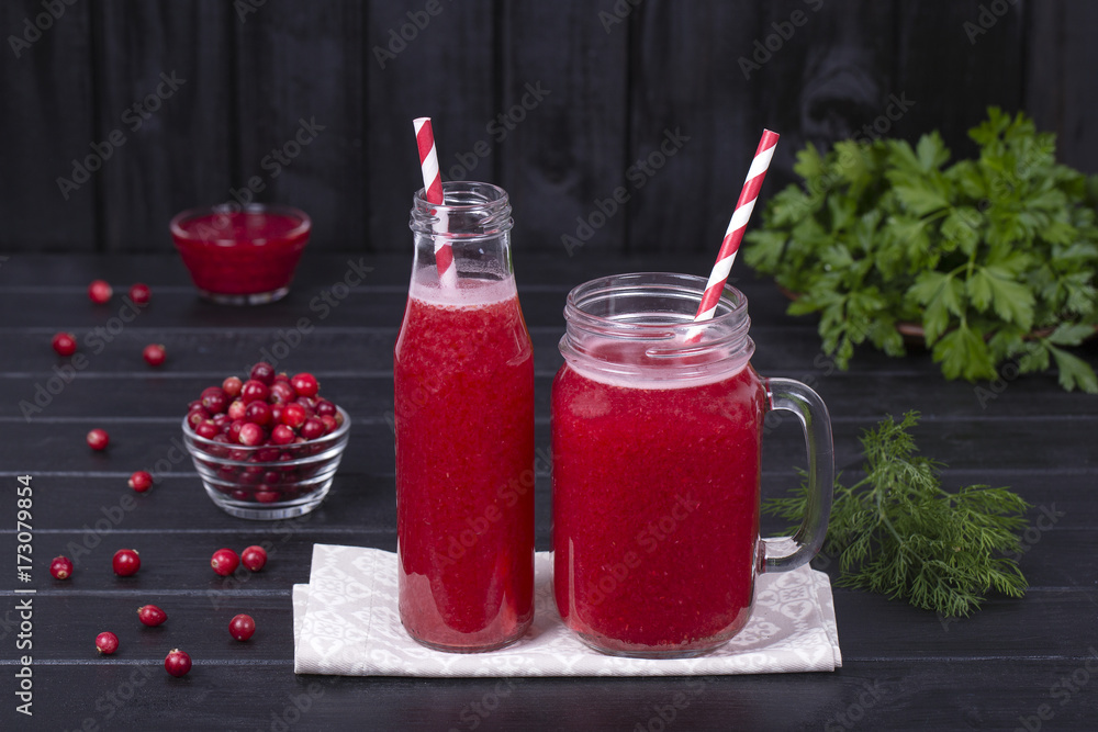 Cranberry juice and raw cranberry on black wooden background, close up ...