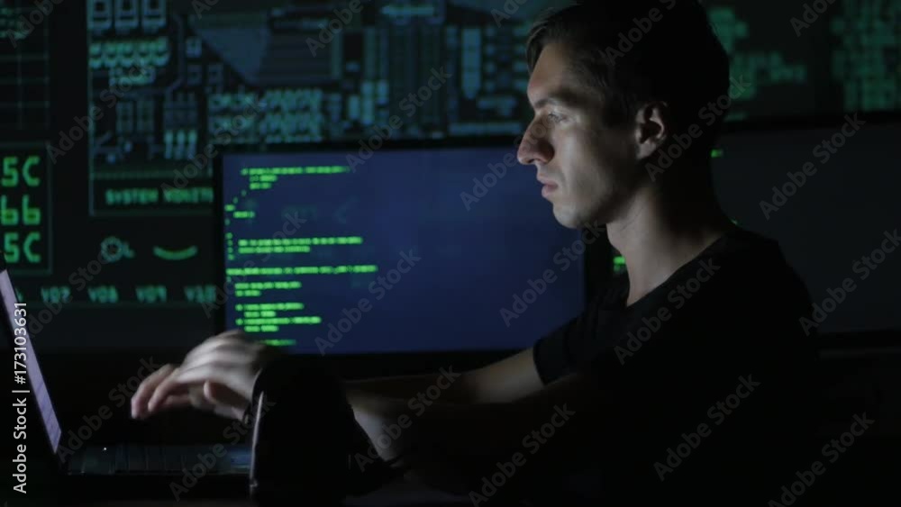 Male hacker programmer uses a virtual reality helmet for programming ...