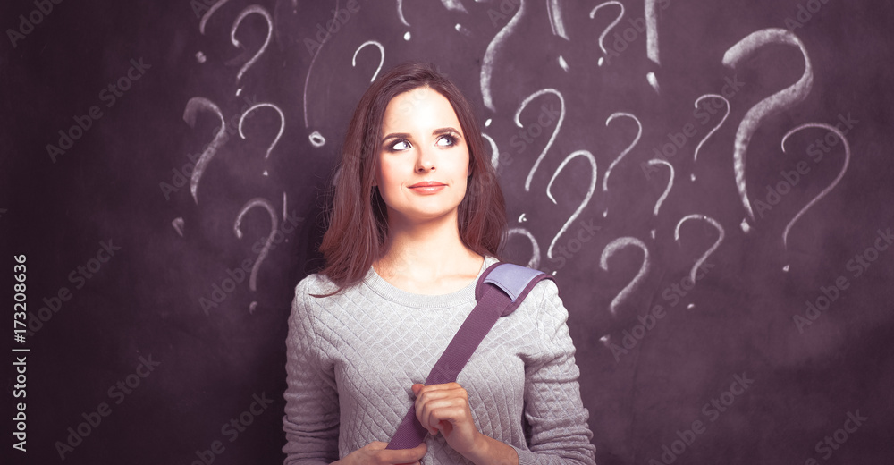 Young girl with question mark on a gray background Stock Photo | Adobe ...