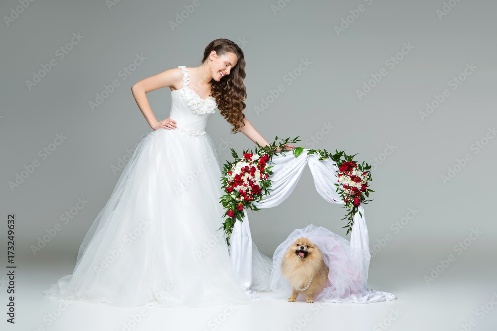 bride girl with dog bride under flower arch Stock Photo | Adobe Stock
