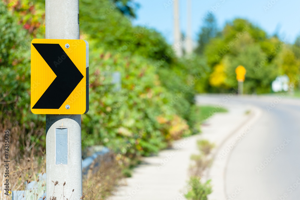 Chevron road sign indicating right turn. Stock Photo | Adobe Stock