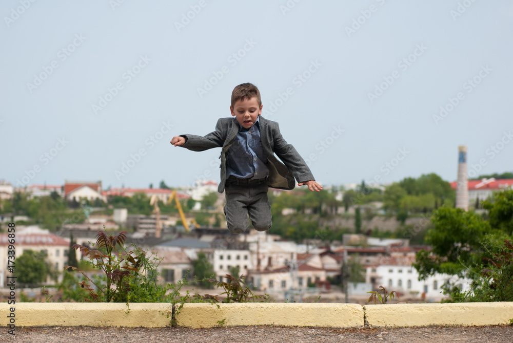 happy little boy jumping up very high Stock Photo | Adobe Stock