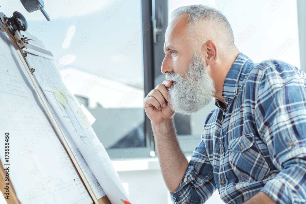 Pleasant old skillful man is working on design plan Stock Photo | Adobe ...