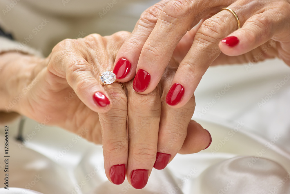 Female manicured hands with diamond. Senior woman hands with red nails ...