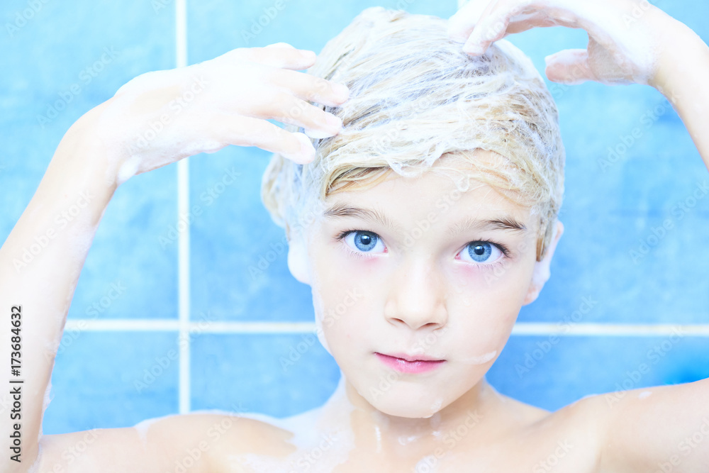 Little child girl with wet long hair takes a bubble bath. Washing her ...