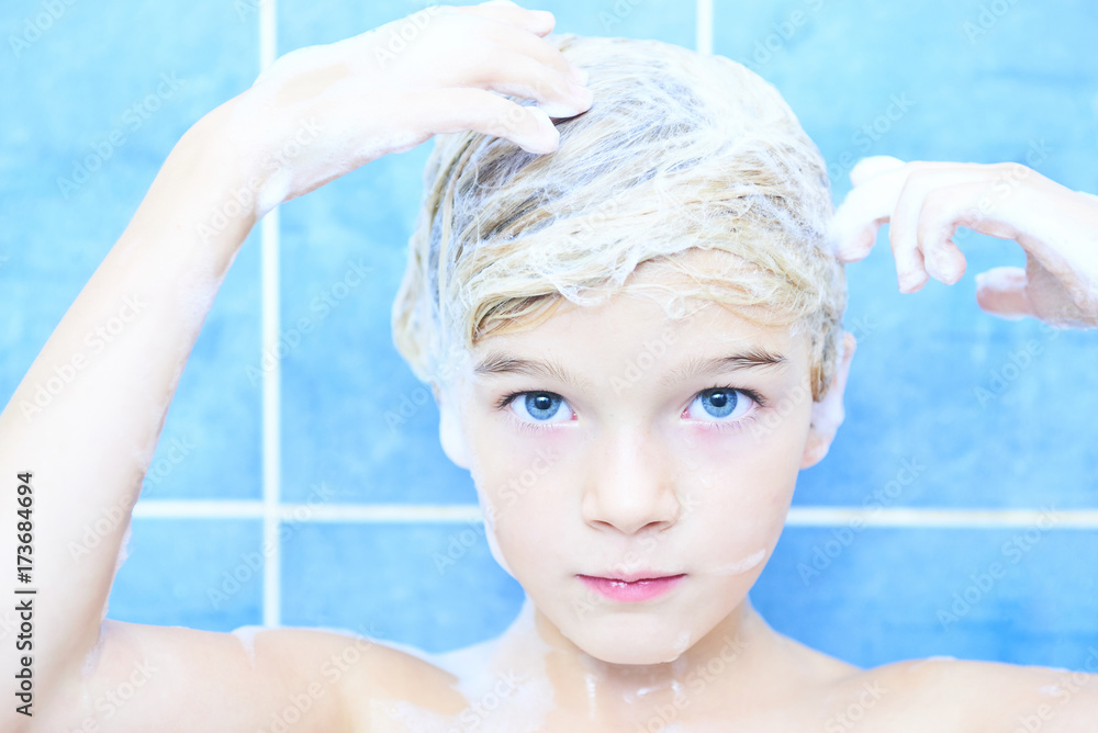 Little child girl with wet long hair takes a bubble bath. Washing her ...
