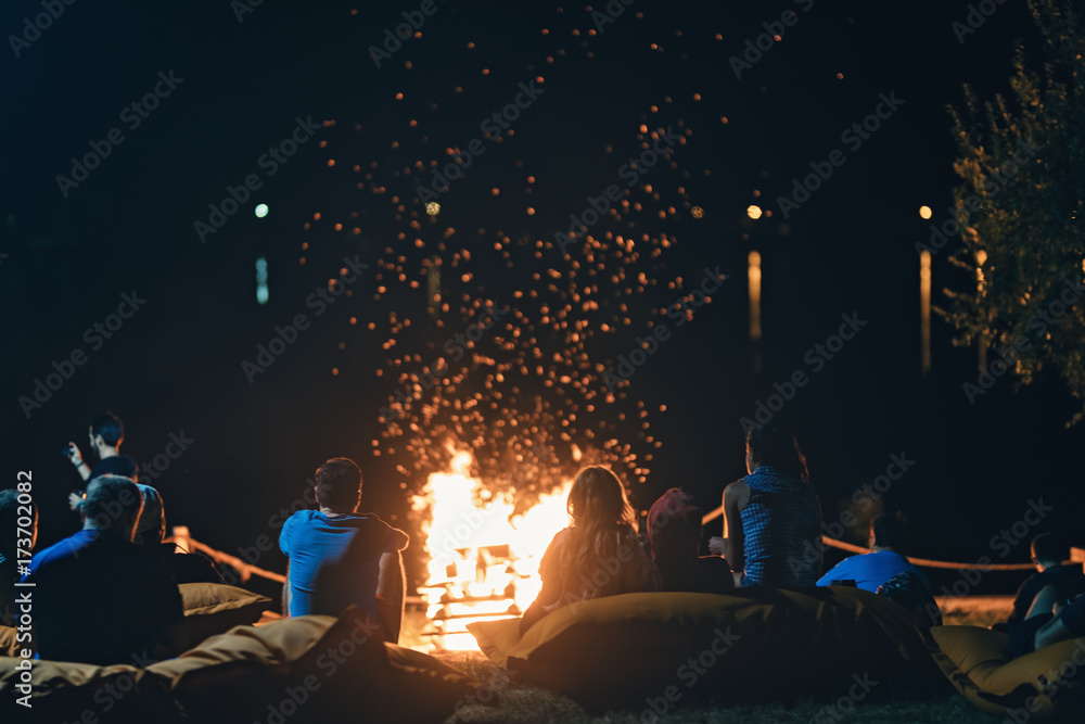 Group of people near camp fire with campfire song and campfire meals ...