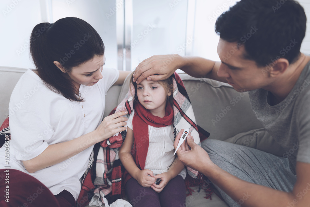 The little girl caught a cold. Her mother and father are treating her ...