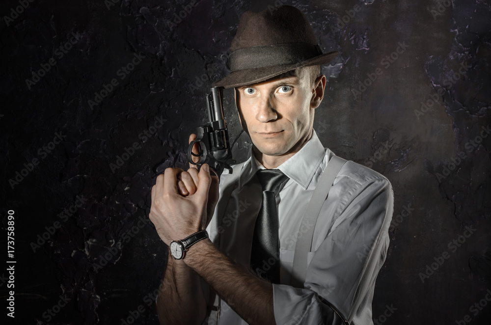 Black and white picture of private detective with gun in both hands ...