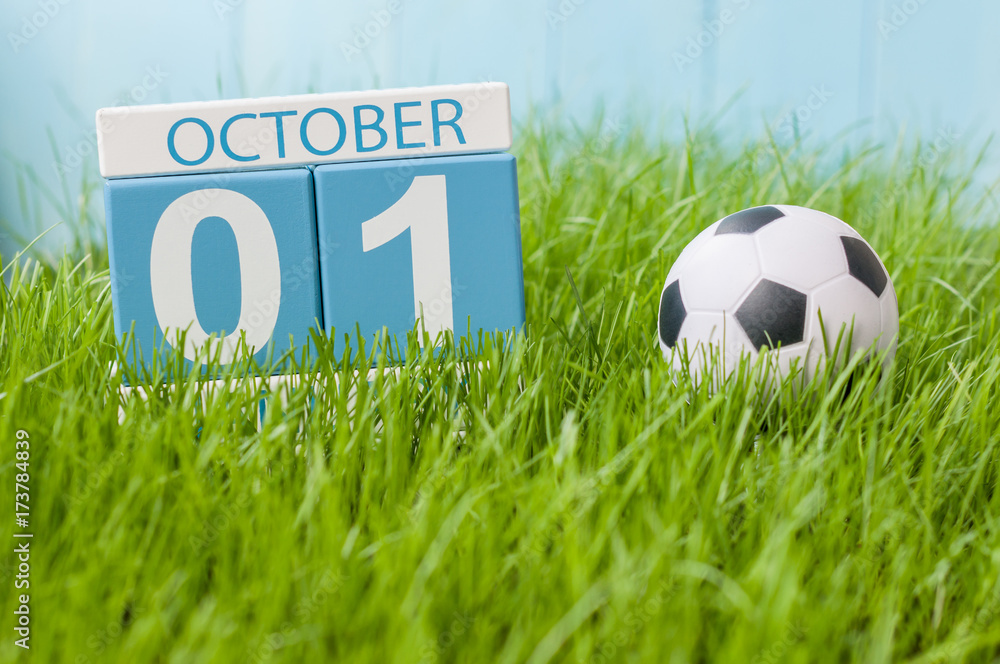 October 1st. Day 1 of month, color calendar on green grass background ...