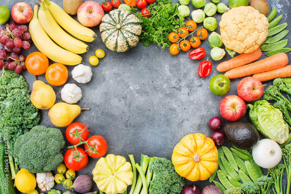 Rainbow colour vegetables arranged in a circle on the dark grey ...