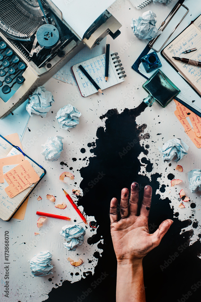 Writer workplace with spilled ink, crumpled paper, scattered letters ...