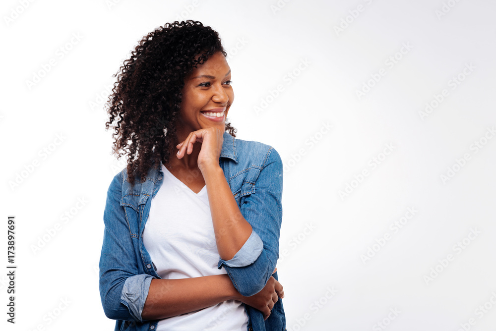 Cheerful woman posing while resting chin on hand Stock Photo | Adobe Stock