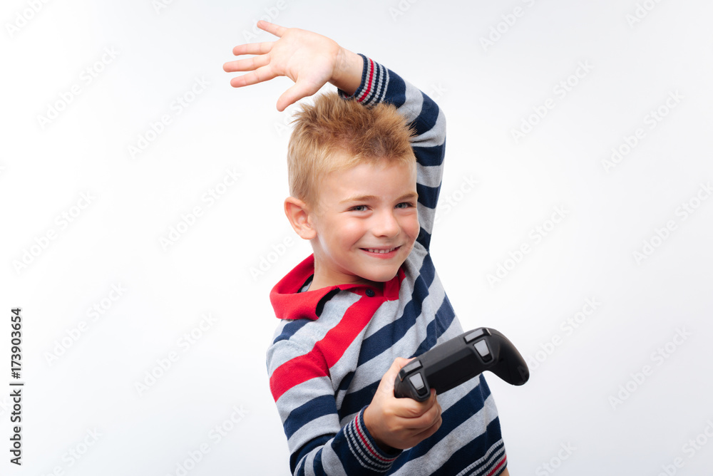 Little boy raising hand and holding game controller Stock Photo | Adobe ...