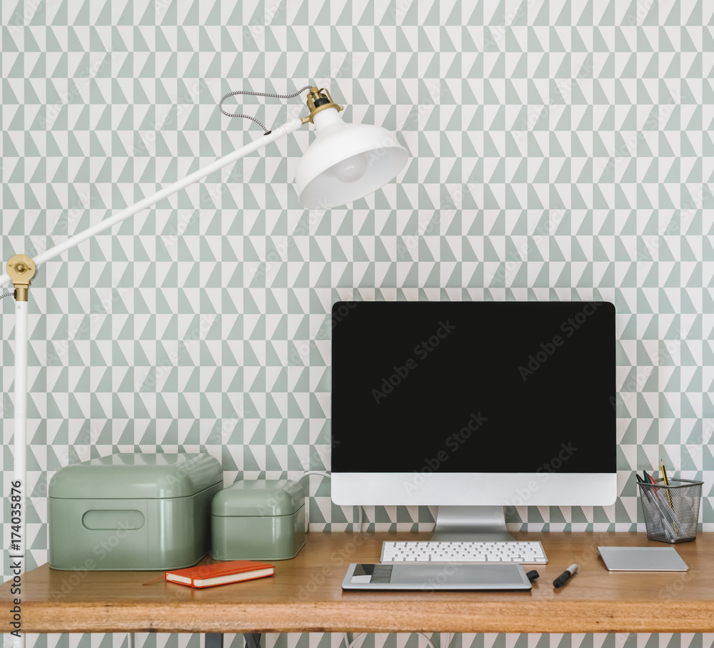 Office workspace with desk and computer against wallpaper Stock Photo ...