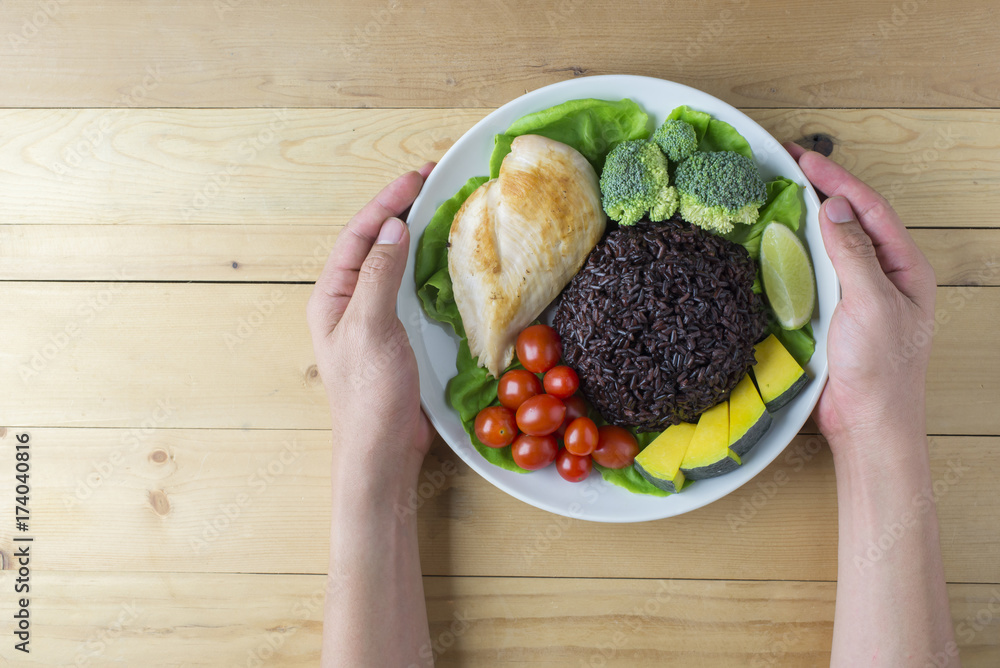 Clean food top view on woo table on disk have vegetable and chicken ...