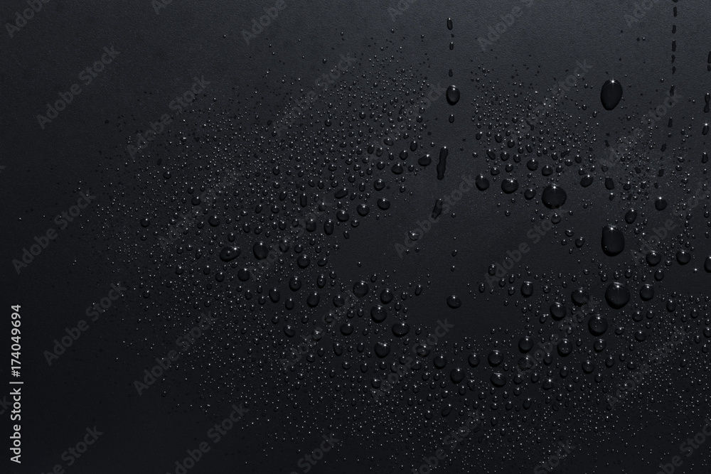 Close-up of black raindrops on dark surface Stock Photo | Adobe Stock