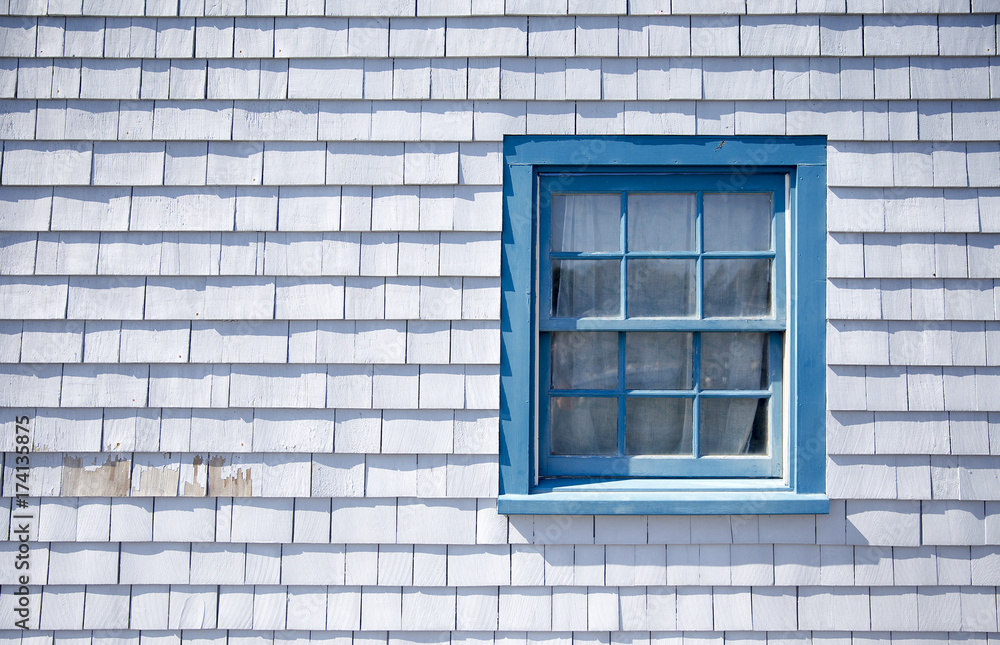 blue window frame on a white wooden wall background outside. part of ...