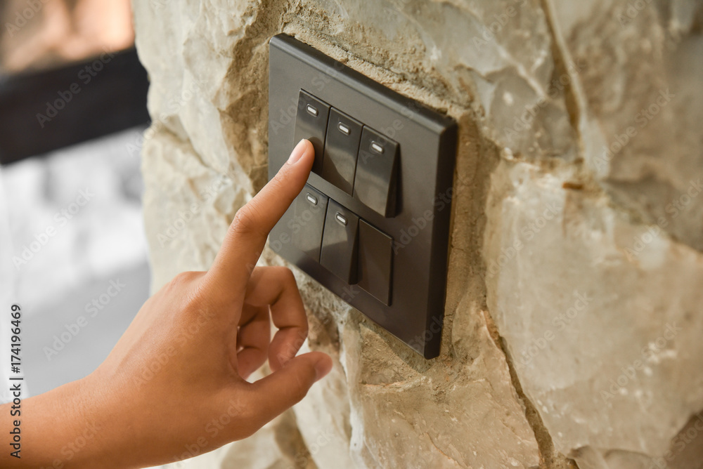 lighting switch on rough stone wall. Stock Photo | Adobe Stock