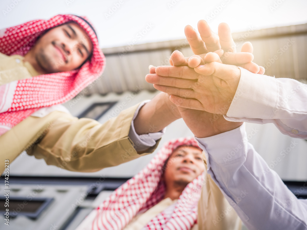 Engineer/architect, arab businessman stacking hands express their ...