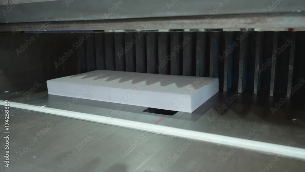 White man puts a pack of white paper in guillotine cutter Stock ビデオ ...