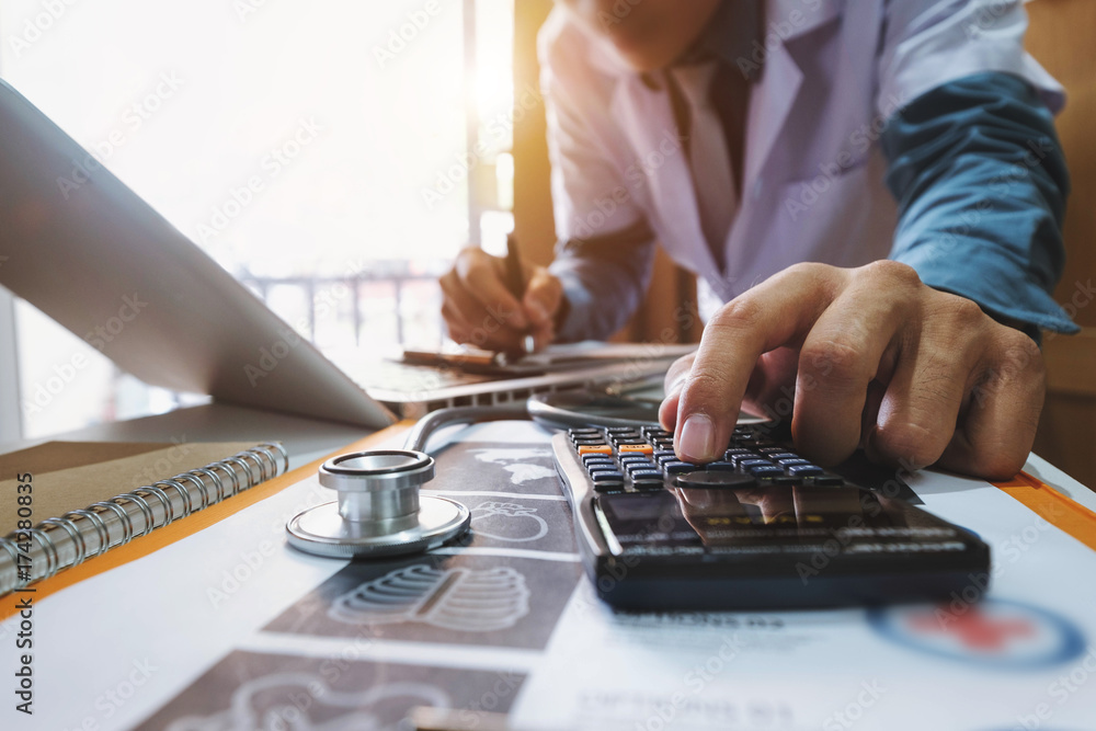 Healthcare costs and fees concept.Hand of smart doctor used a ...