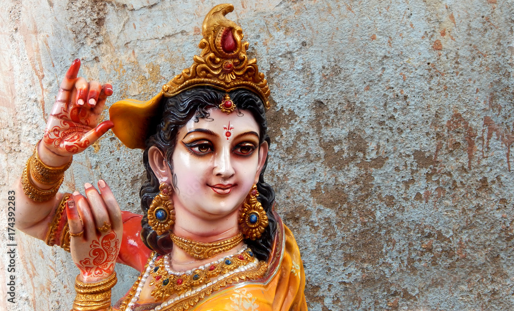 Statue of Indin Hindu Goddess Radha in traditional dress and jewelry in ...