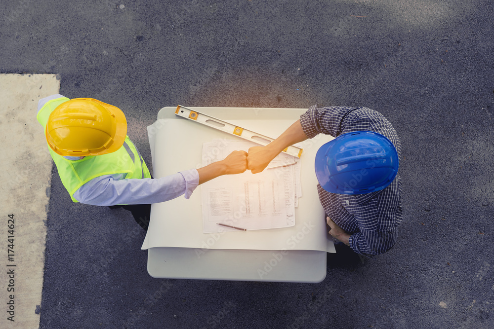 Giving fist bump hands of engineer men together teamwork partner and ...