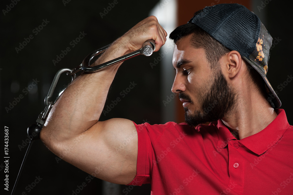 Handsome fitness model showing biceps muscles Stock Photo | Adobe Stock